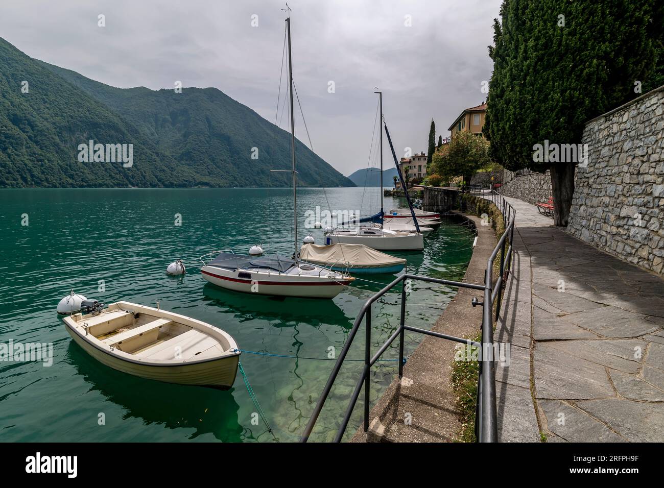 The lakeside promenade of Gandria, Lugano, Switzerland, on a summer day ...