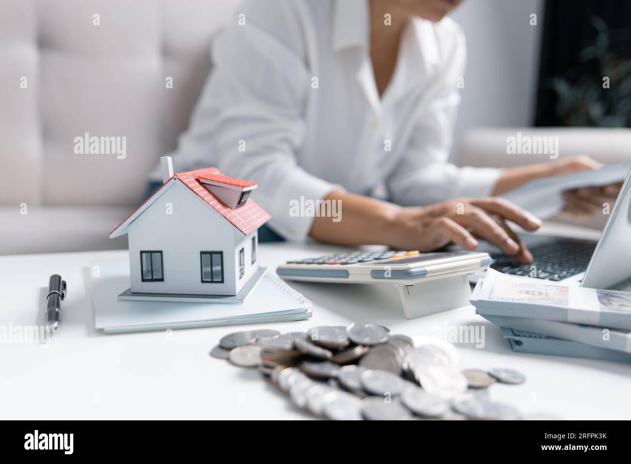 Concentrated Asian woman calculating expenditures, analyzing paper bank ...