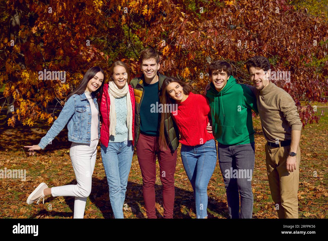 Group of happy friends smiling at camera hugging on nature Stock Photo ...