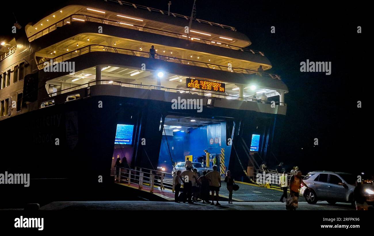 Ferry-boat landing at night in Gavrio harbor, Gavrio, Andros Island ...