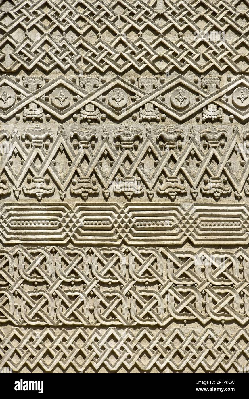 Carved embossed patterns on the stone wall of an ancient church ...