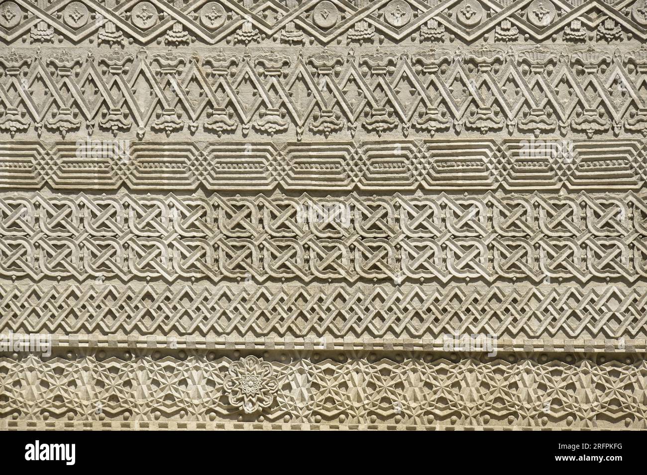 Carved embossed patterns on the stone wall of an ancient church ...