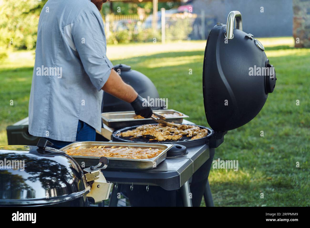 Man cooks barbecue on skewers hi-res stock photography and images - Alamy
