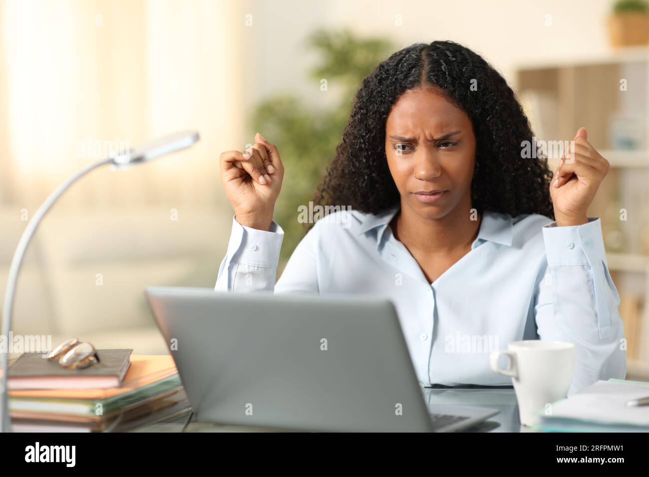 Confused freelancer checking laptop online content tele working at home ...