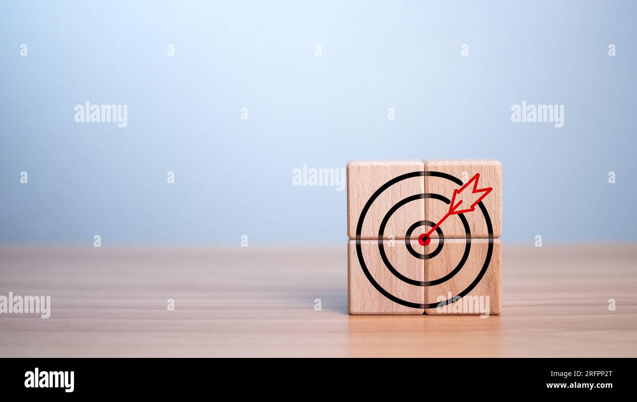 Wooden block and target icon placed on wooden background. Business ...