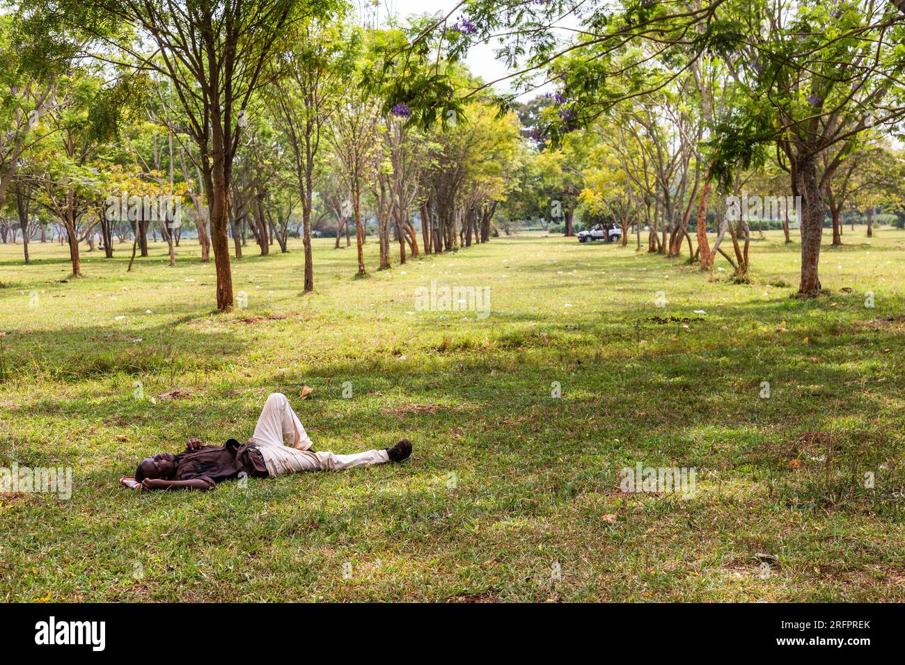 Man lying down taking a nap in Coronation Park in Jinja, Uganda Stock ...