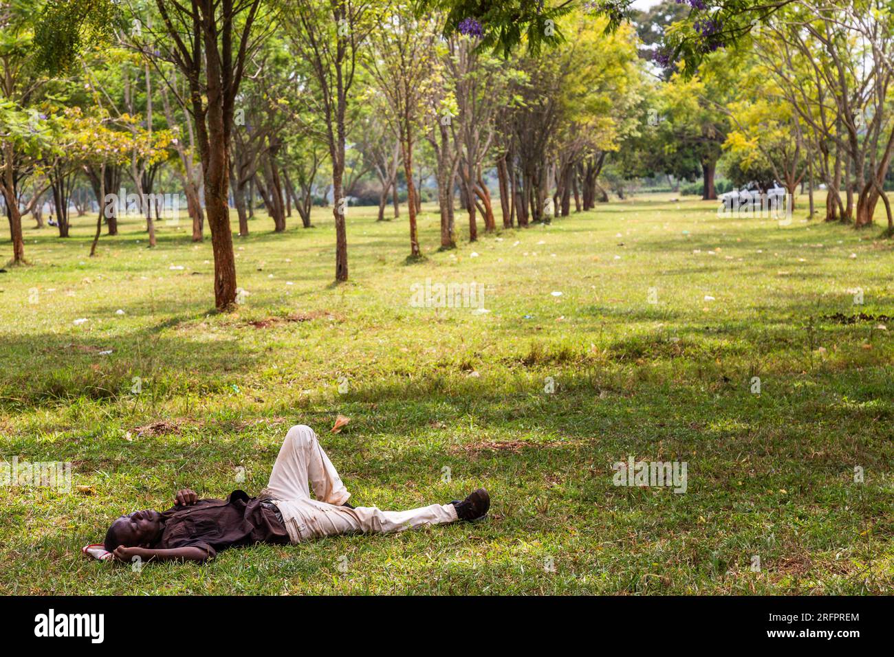 Man lying down taking a nap in Coronation Park in Jinja, Uganda Stock ...