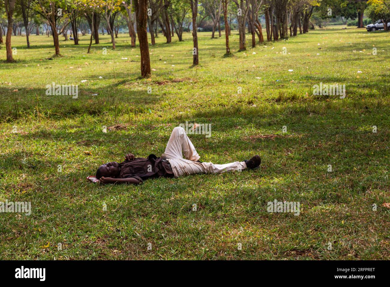 Man lying down taking a nap in Coronation Park in Jinja, Uganda Stock ...