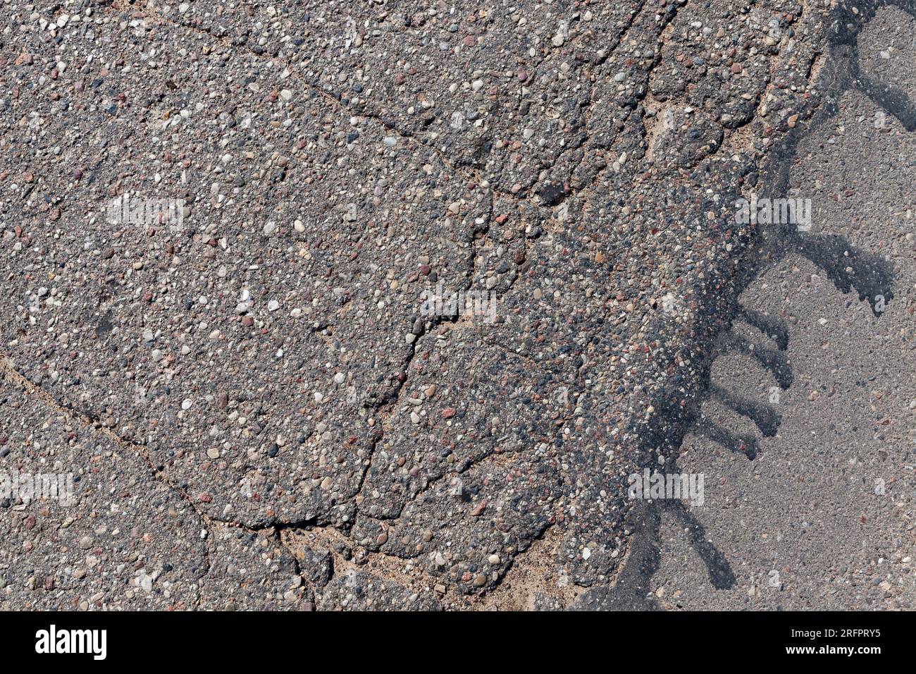an asphalt road with a lot of holes and potholes, a poorly made asphalt ...