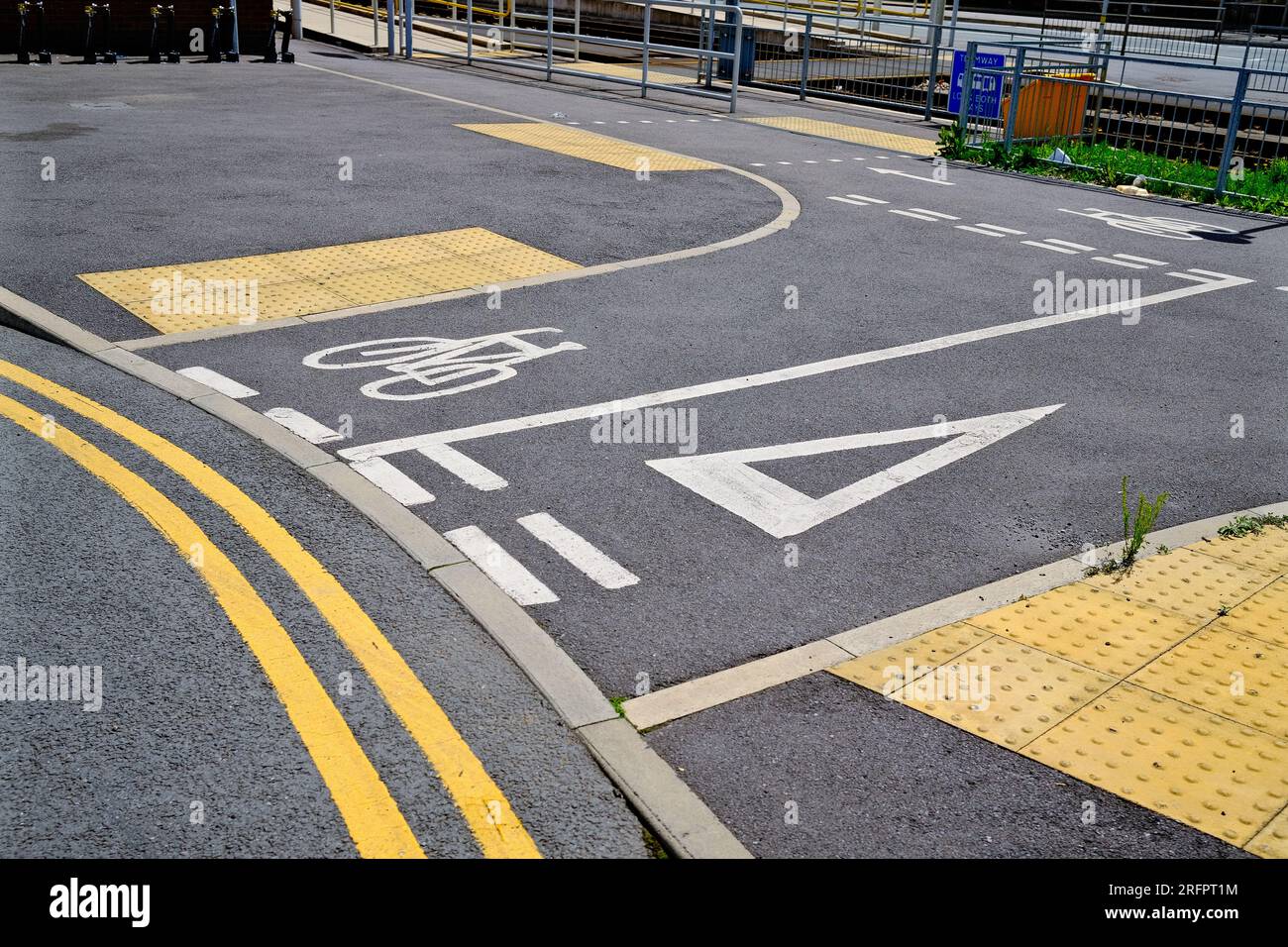 City street with road markings, signage, and pedestrian crossing symbol ...