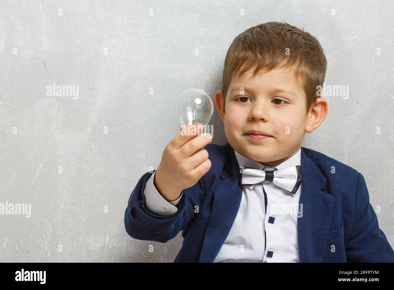 little kid holding a light-bulb Stock Photo - Alamy