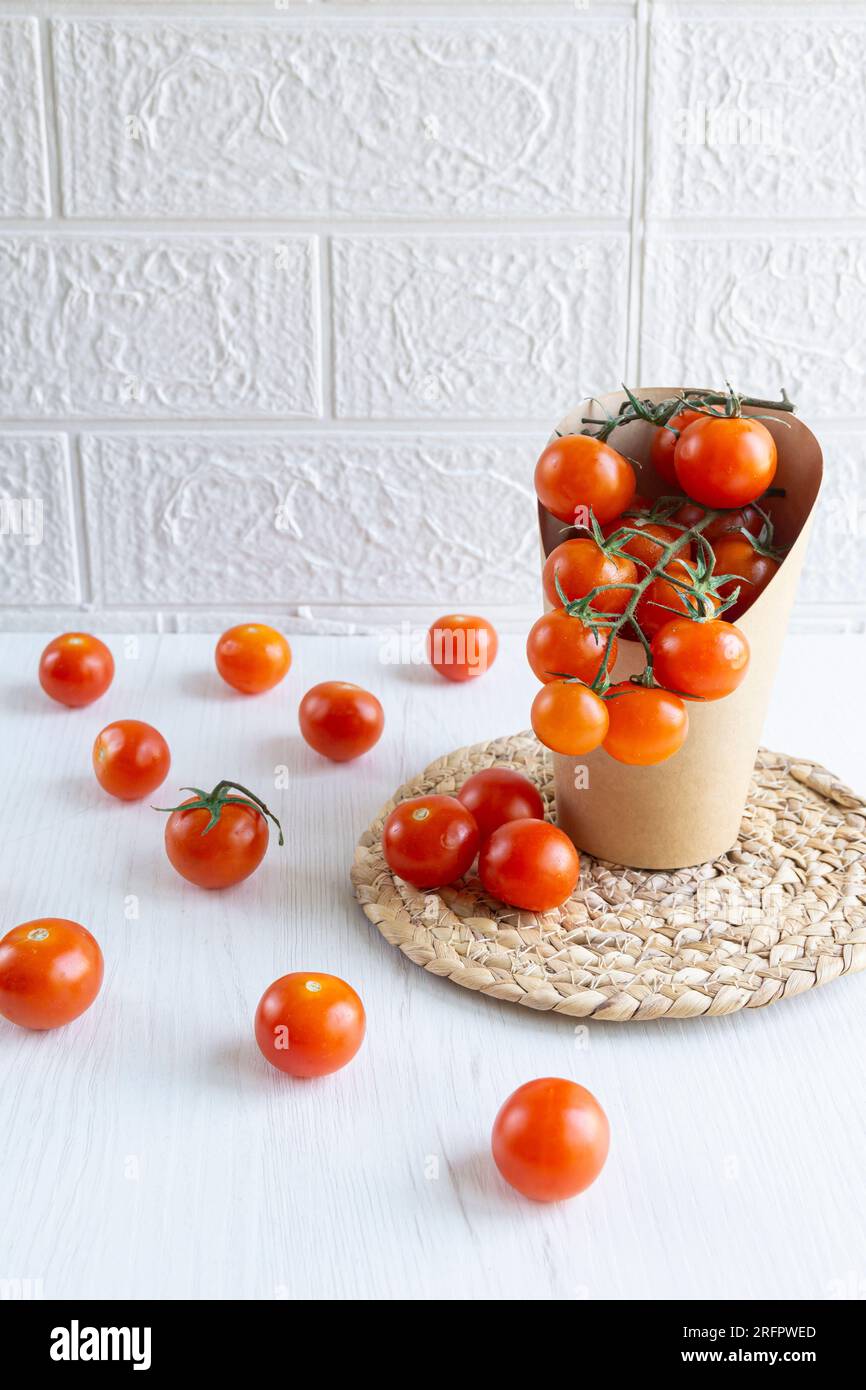 Front view of a cardboard packaging containing cherry tomatoes. Zero ...