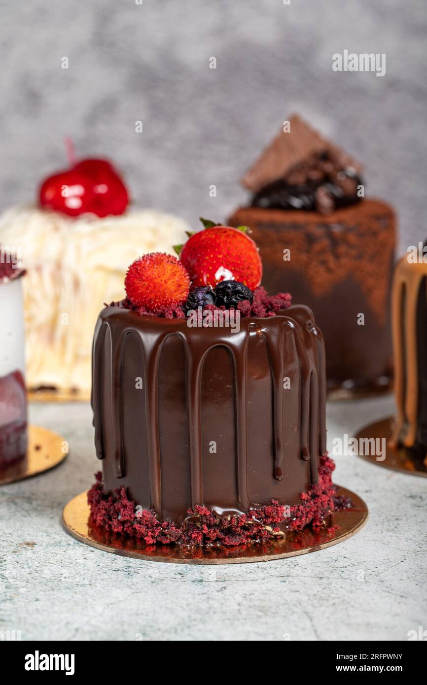Types of cakes. Assortment of chocolate and fruit cakes on a gray ...