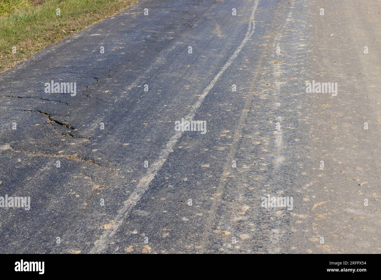 Details of a road polluted with sand and debris from fields, sand and ...