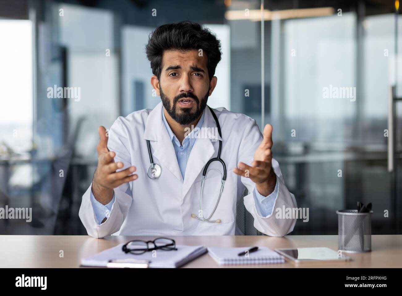 Male doctor seriously talking camera hi-res stock photography and ...