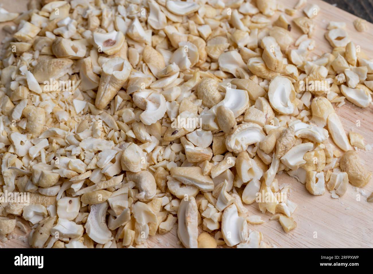 Delicious cashew nuts on a wooden surface, ready to eat and peeled ...