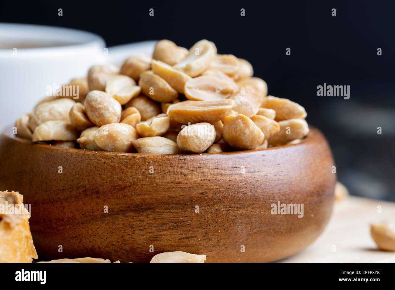 Peeled and roasted peanuts on the table, a pile of whole and half ...
