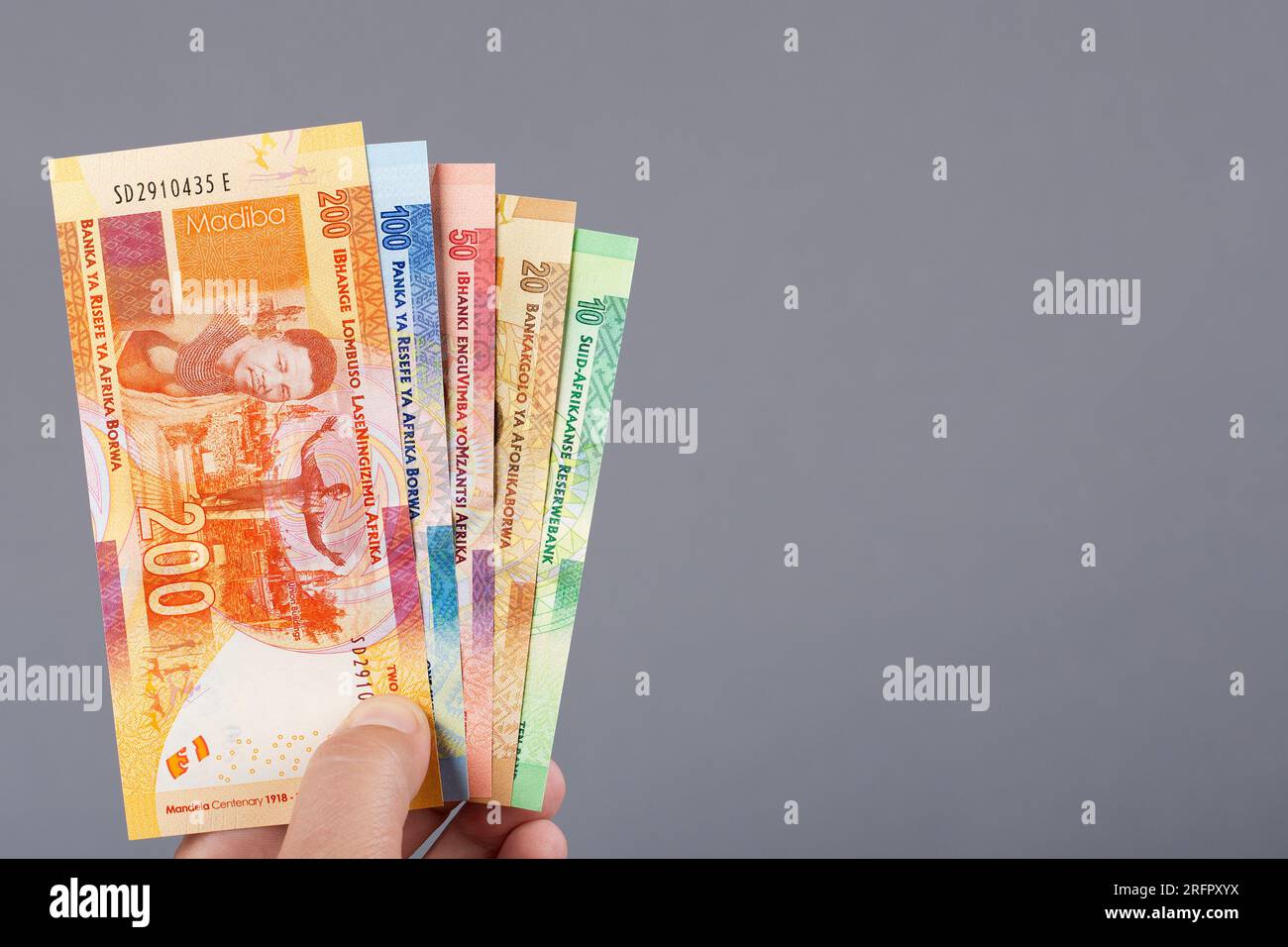 South African money - rand in the hand on a gray background Stock Photo ...