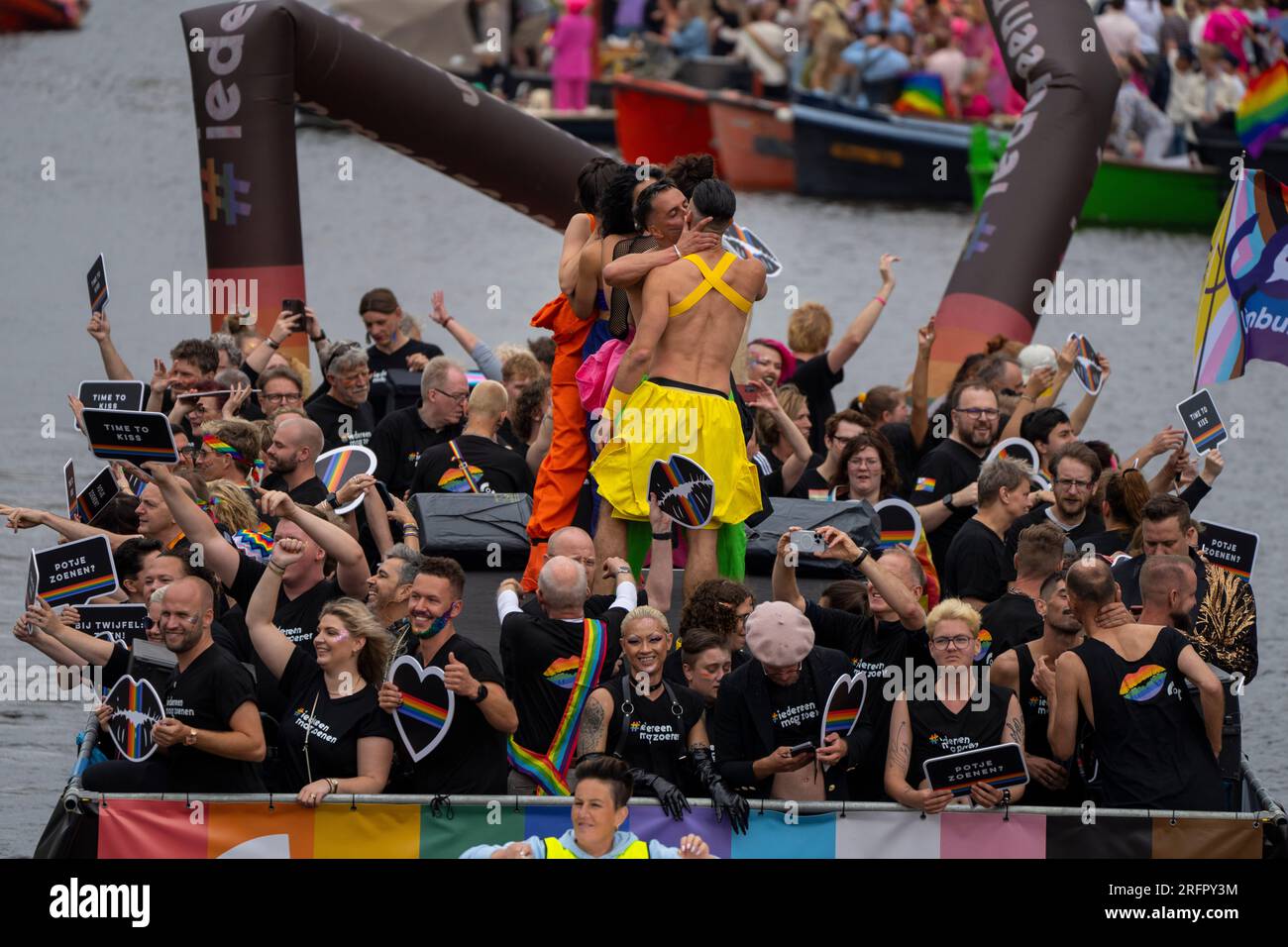 Two men kiss on one of the boats who paraded under gray skies in the Dutch capital's historic ...