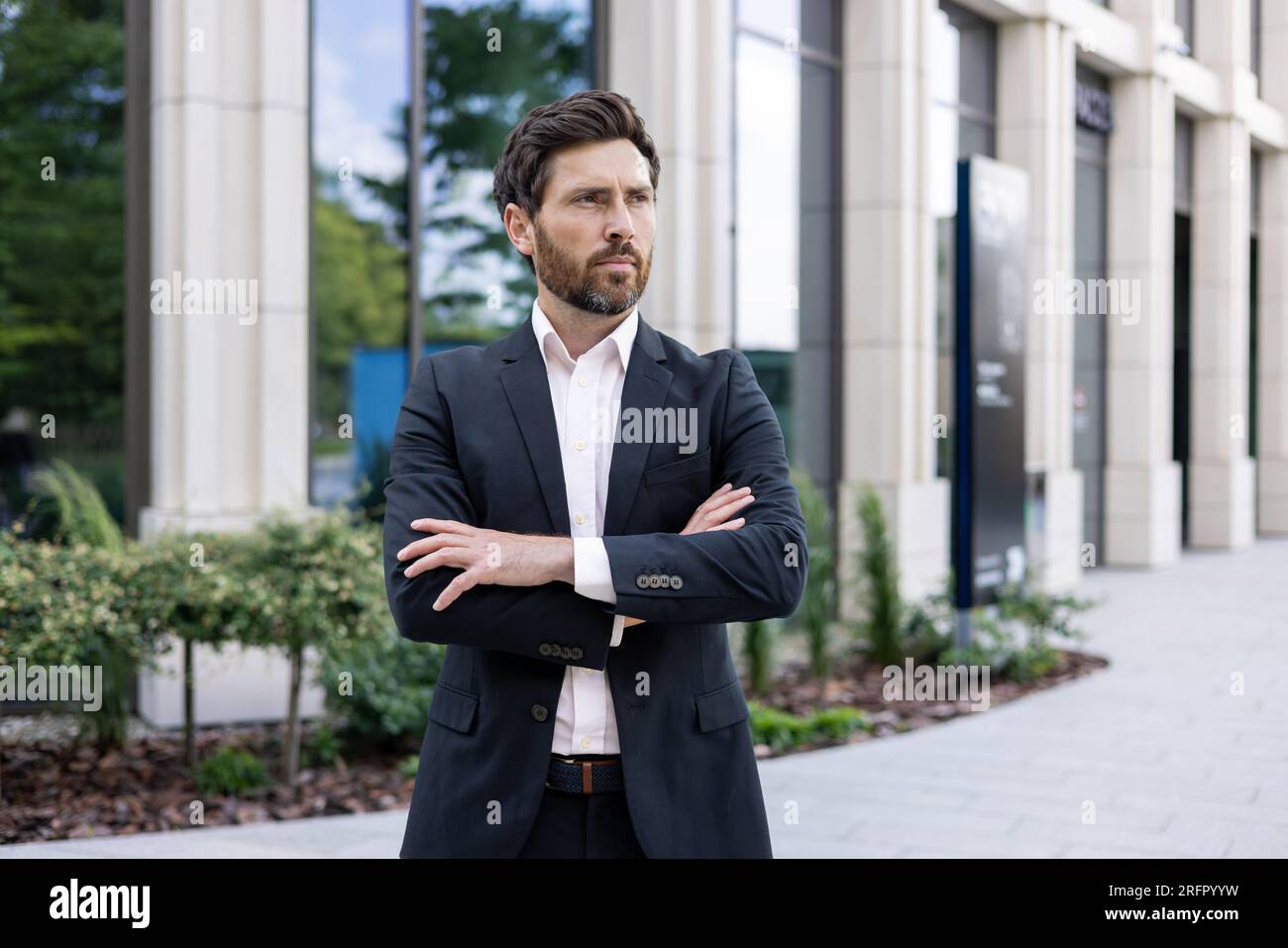 Portrait of a young successful male politician standing outside the ...