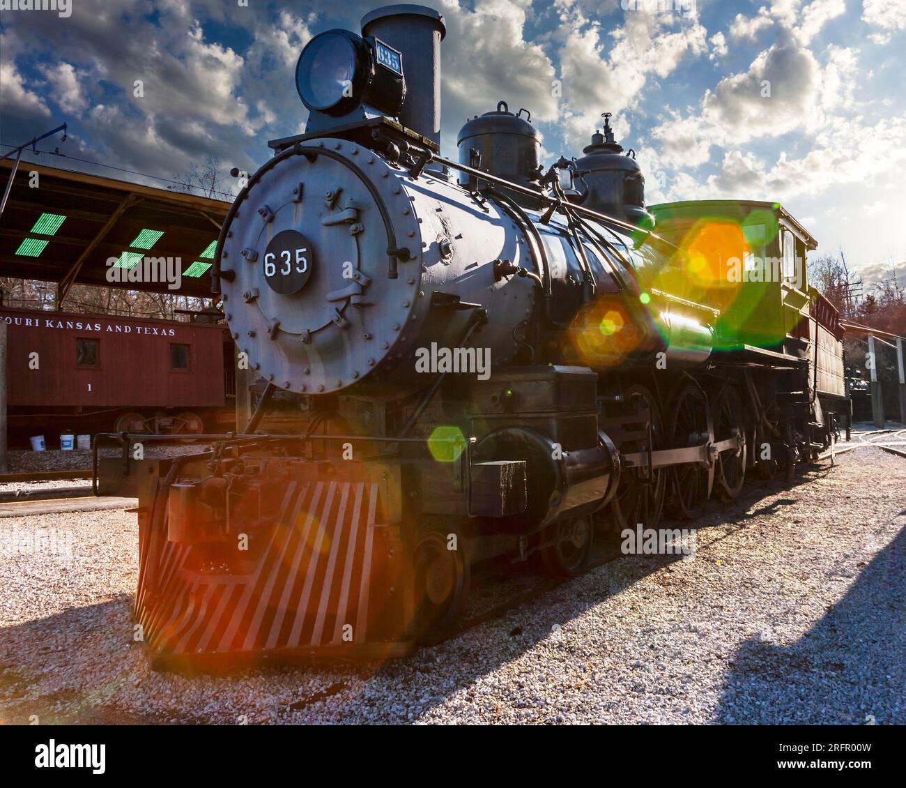 vintage steam engine train showing its age rests under a dramatic sky ...