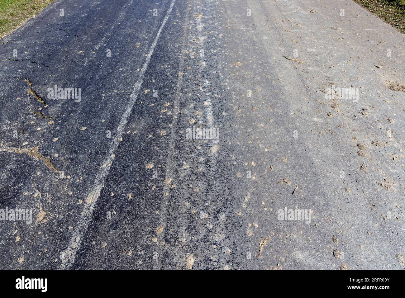 Details of a road polluted with sand and debris from fields, sand and ...