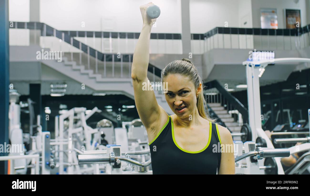 Fit Athletic Woman Exercises with Dumbbell. Muscular Women Training in ...