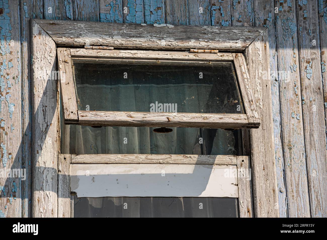 The window of the old wooden log house on the background of wooden ...