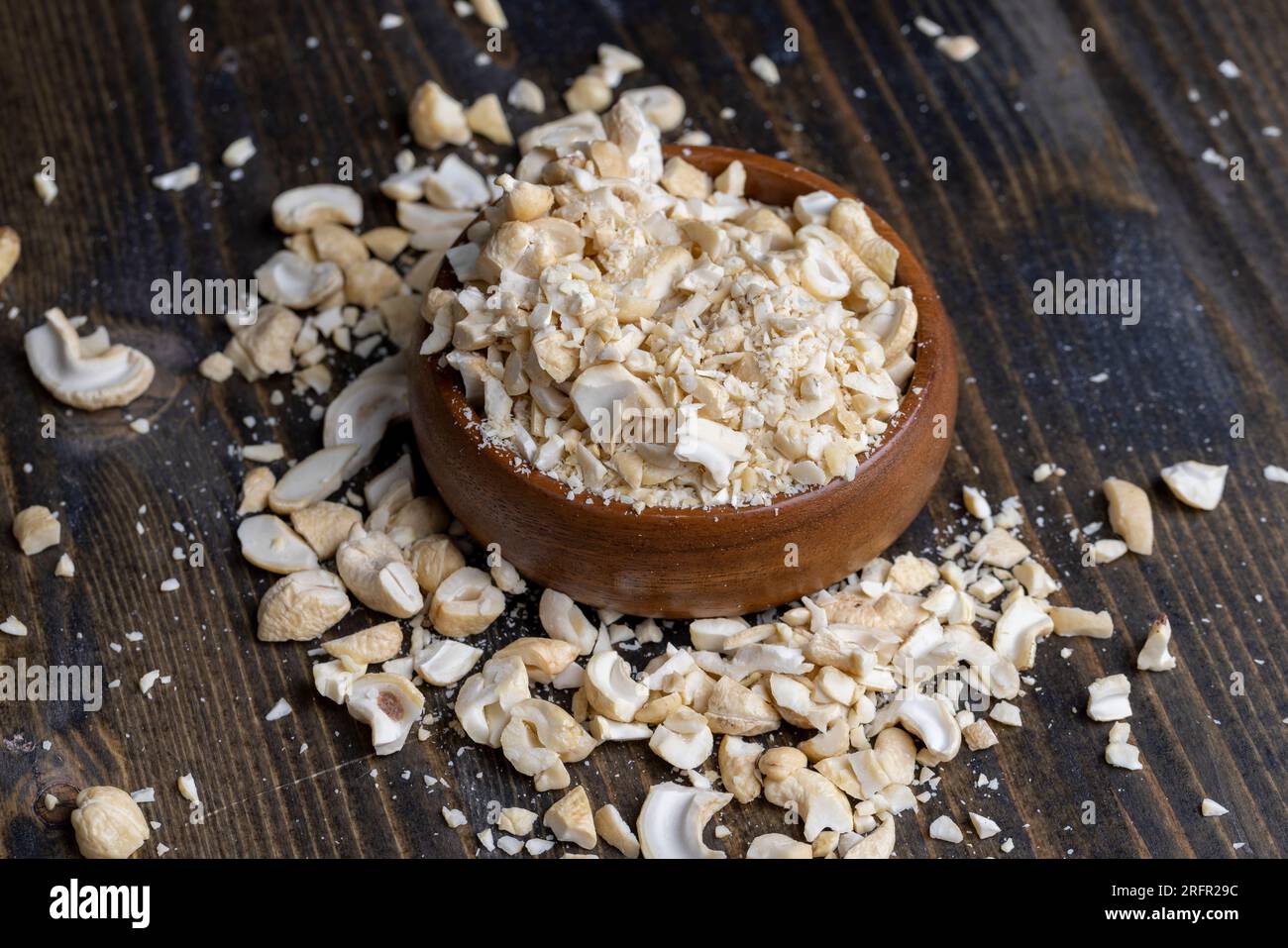 Delicious cashew nuts on a wooden surface, ready to eat and peeled ...