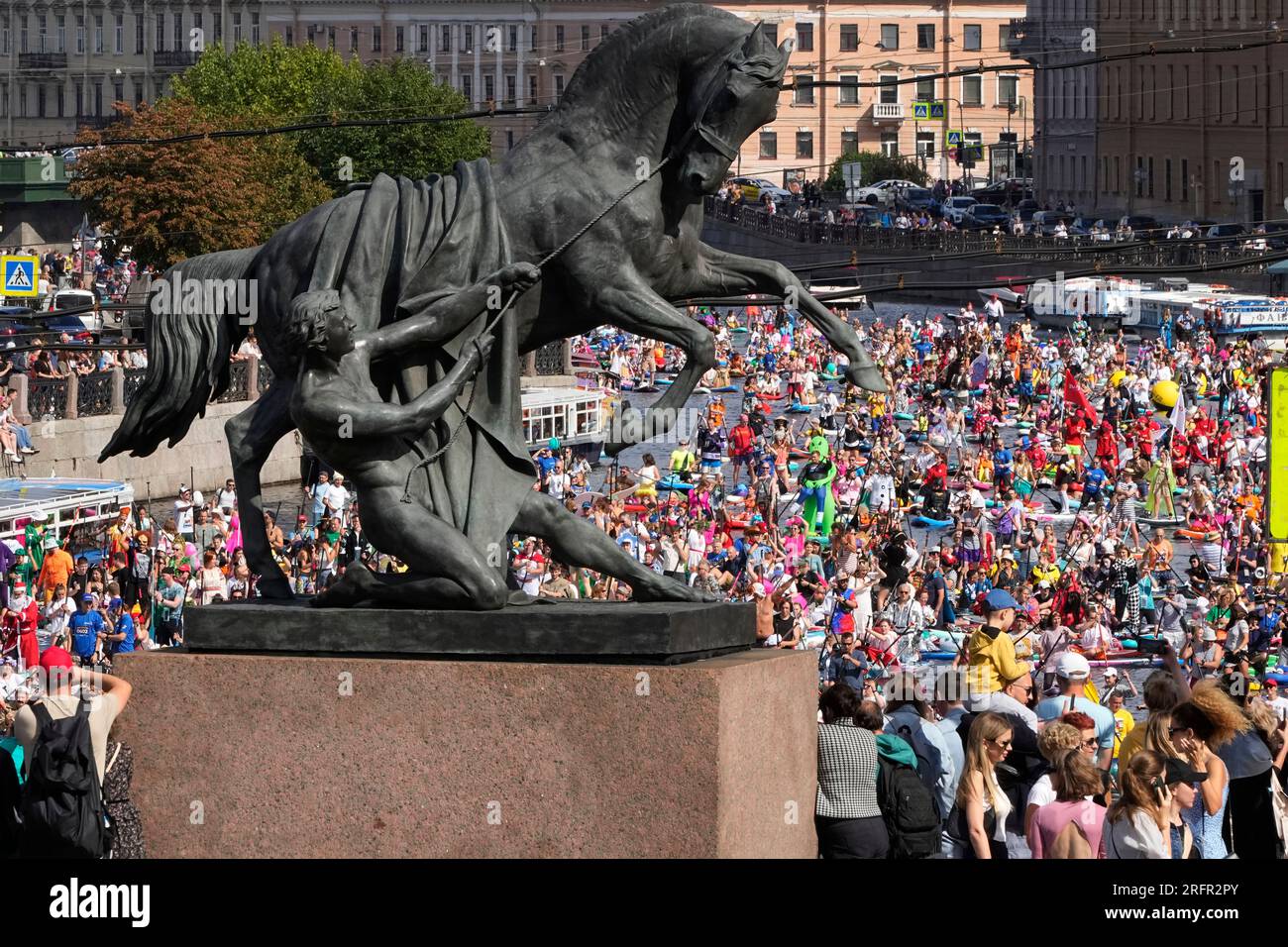 People steer their stand-up paddle (SUP) boards along the Fontanka ...