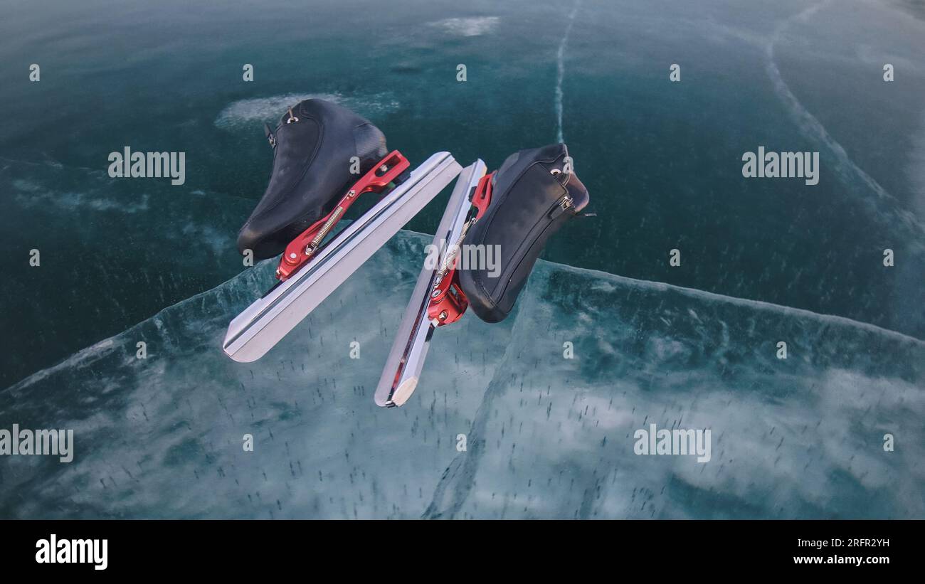 The skates boots are on the ice. The child train on ice speed skating ...