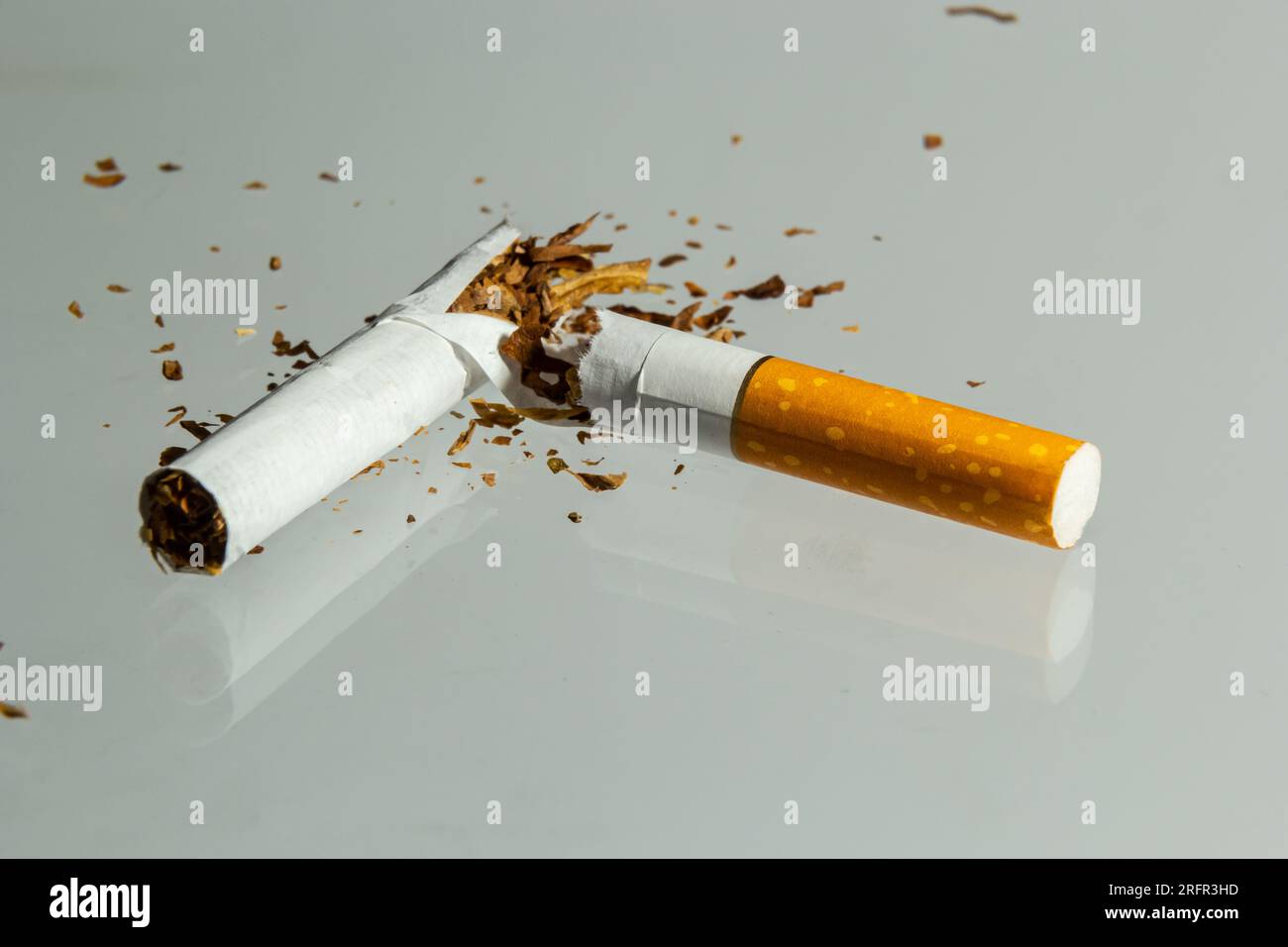 Broken cigarette fly in air on a light background. Conception of ...