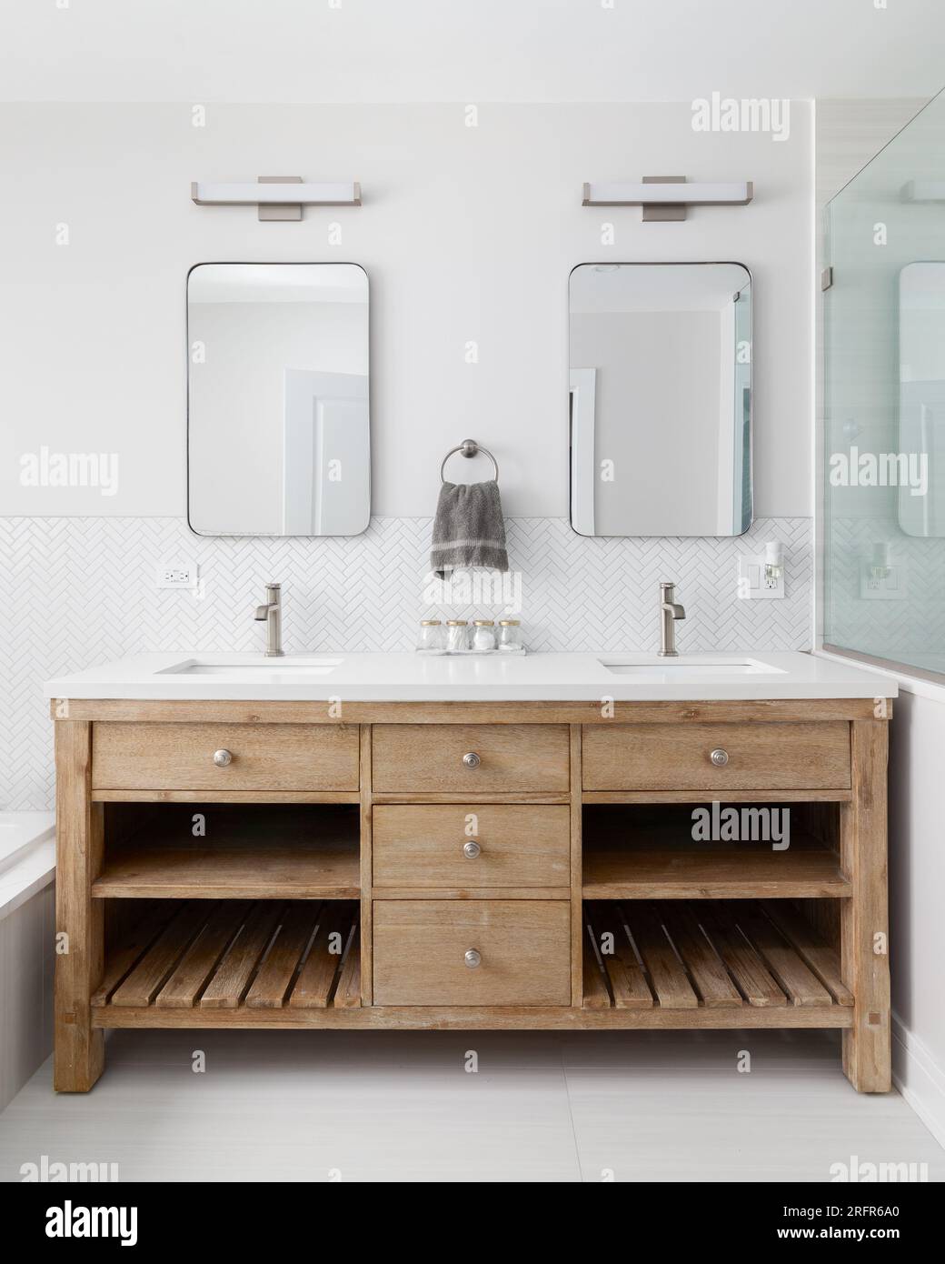 A cozy bathroom detail with a white oak vanity cabinet, white ...