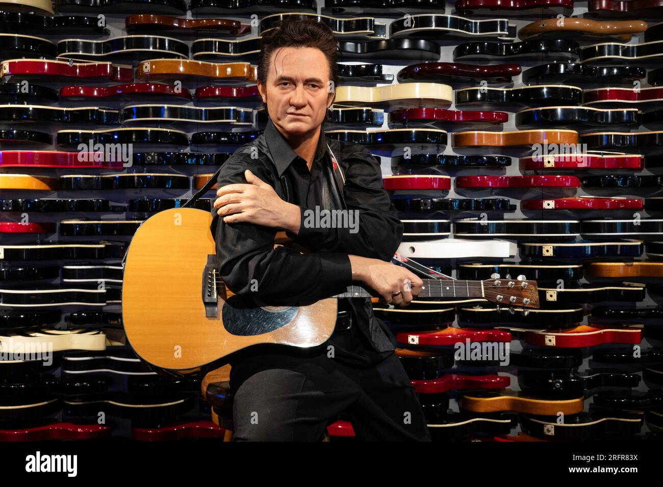 Johnny Cash, Madame Tussauds wax statue, stands in front of the guitar ...
