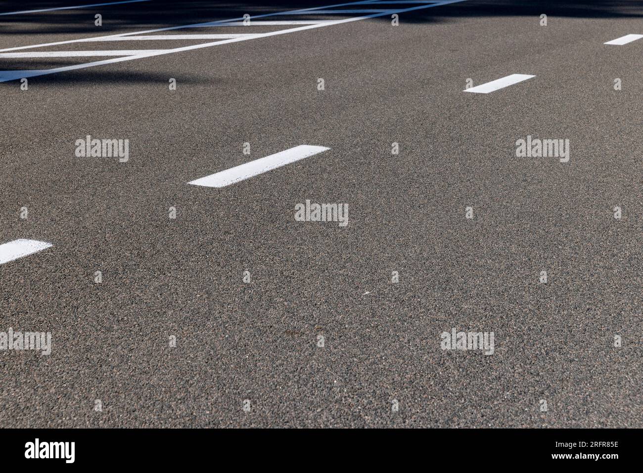 Paved highway with white road markings, traffic regulation using lines ...