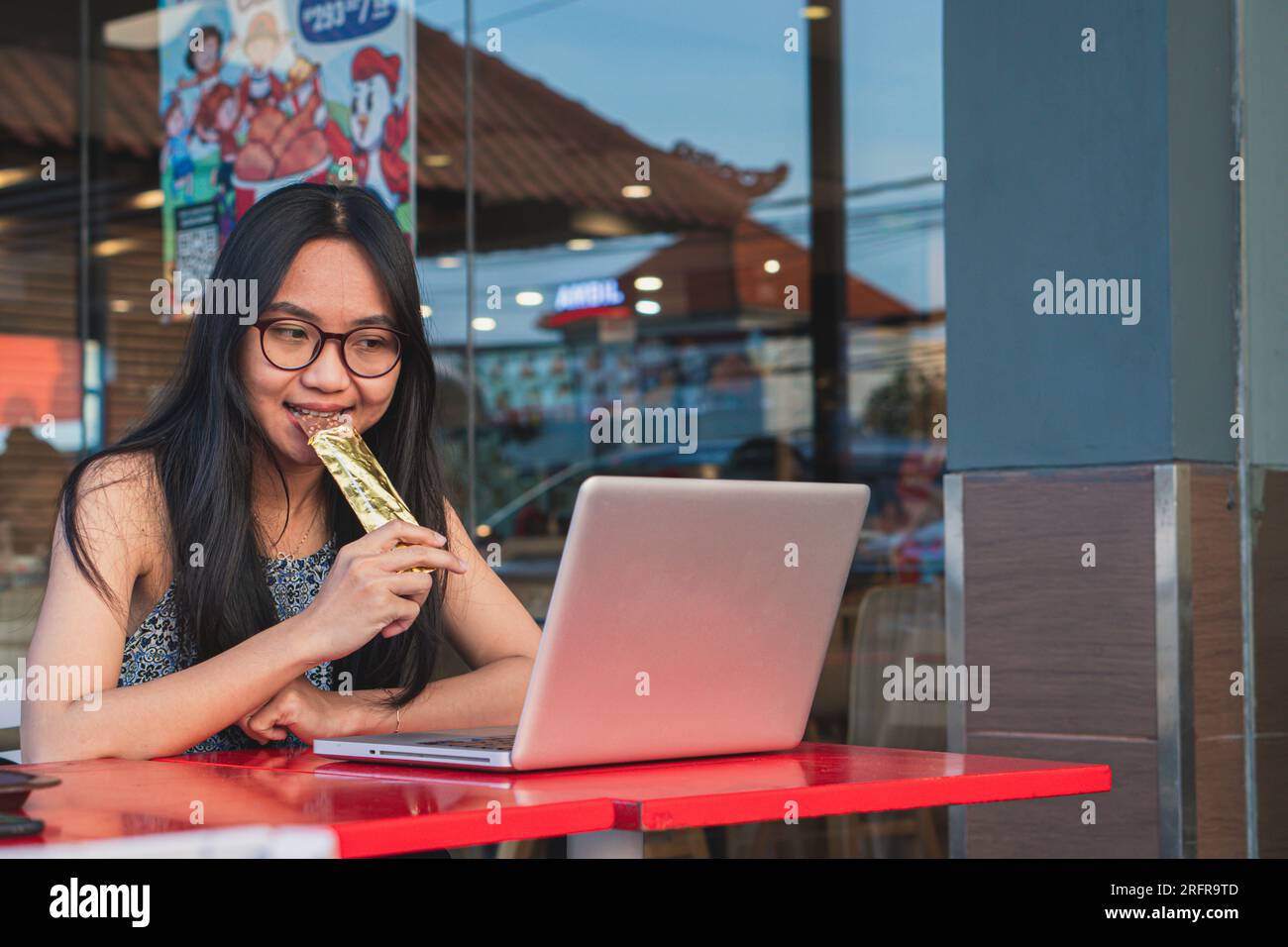 Close up young happy woman biting chocolate bar. People lifestyle food ...