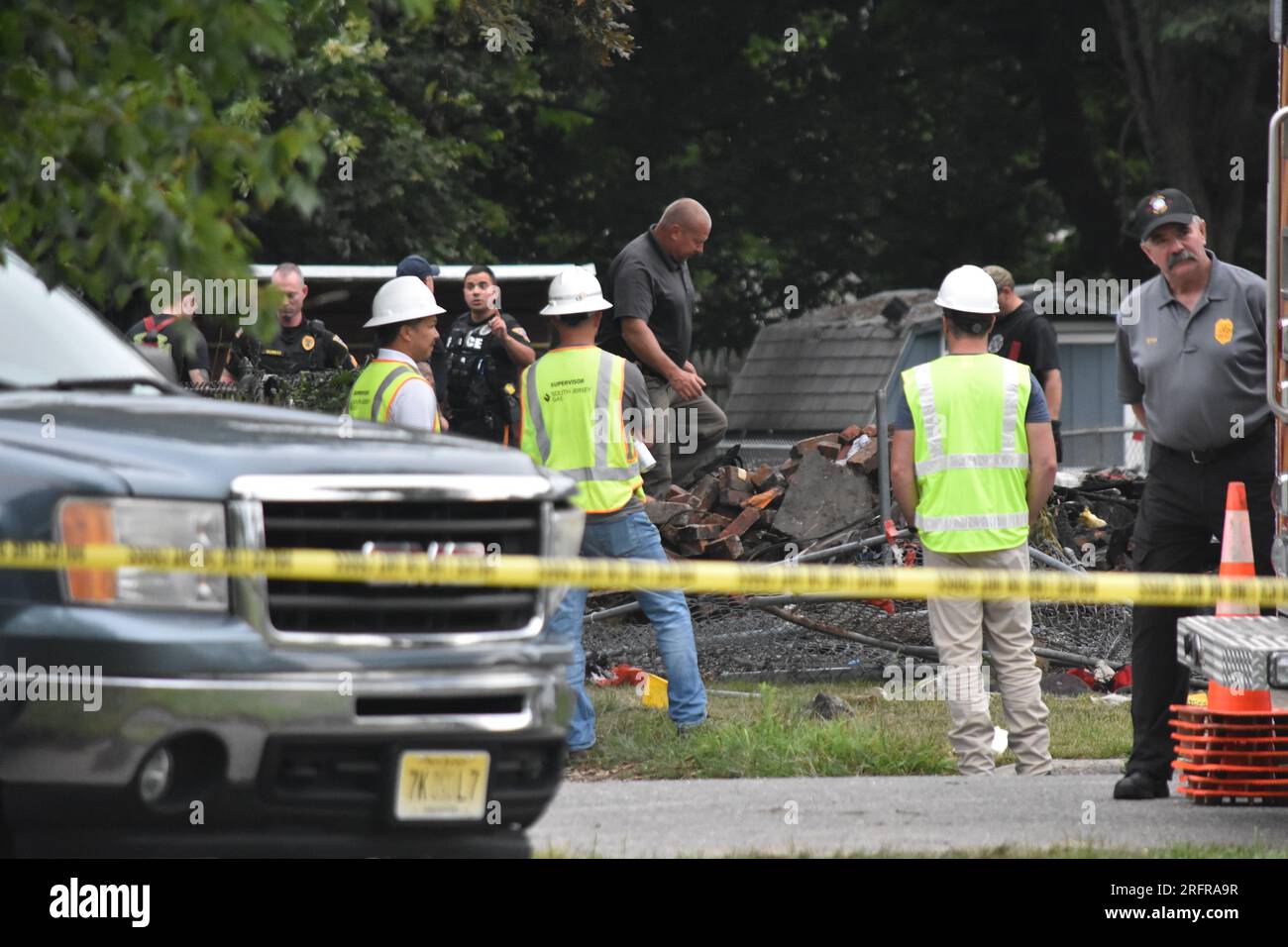 Investigators secure the crime scene and place crime scene tape at the ...