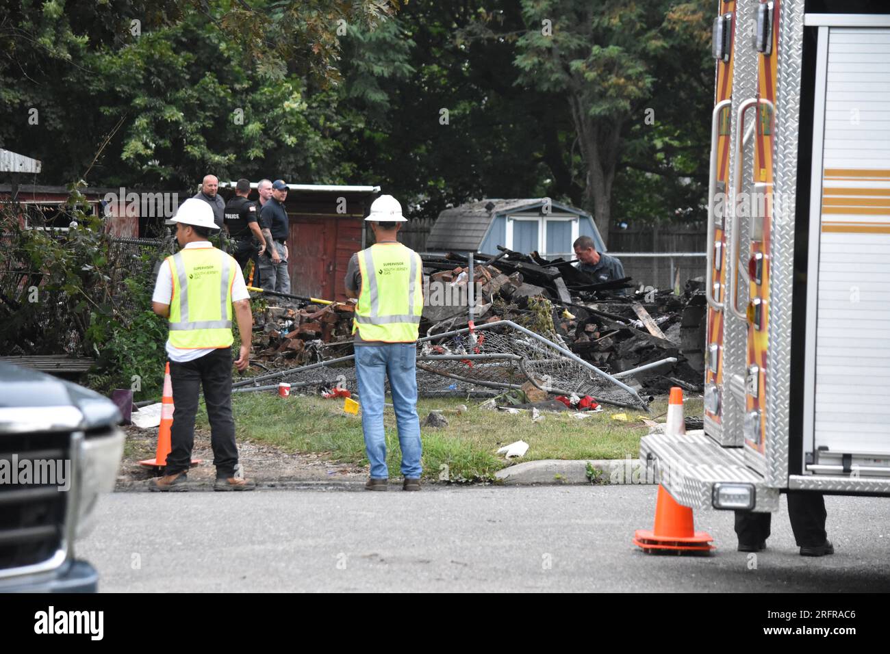 Investigators secure the crime scene and place crime scene tape at the ...