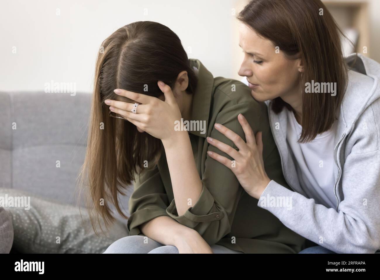 Mum hugging crying daughter adult hi-res stock photography and images ...