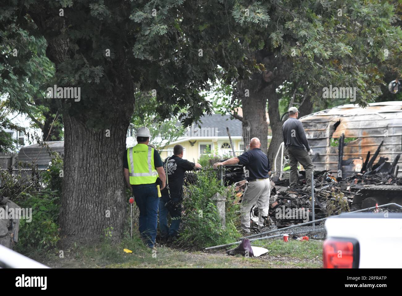Investigators secure the crime scene and place crime scene tape at the ...
