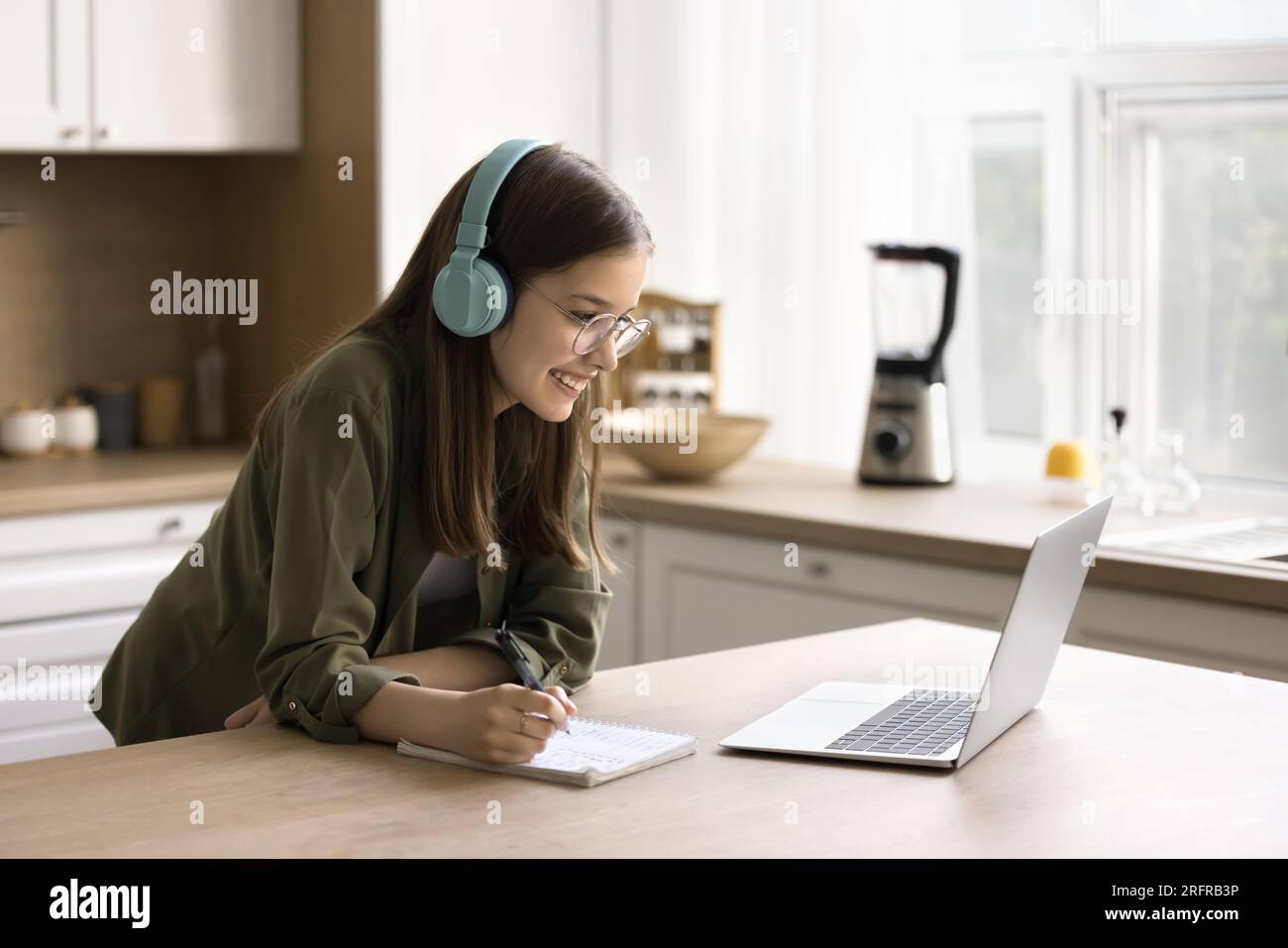 Positive teenager school kid talking on video conference call Stock ...