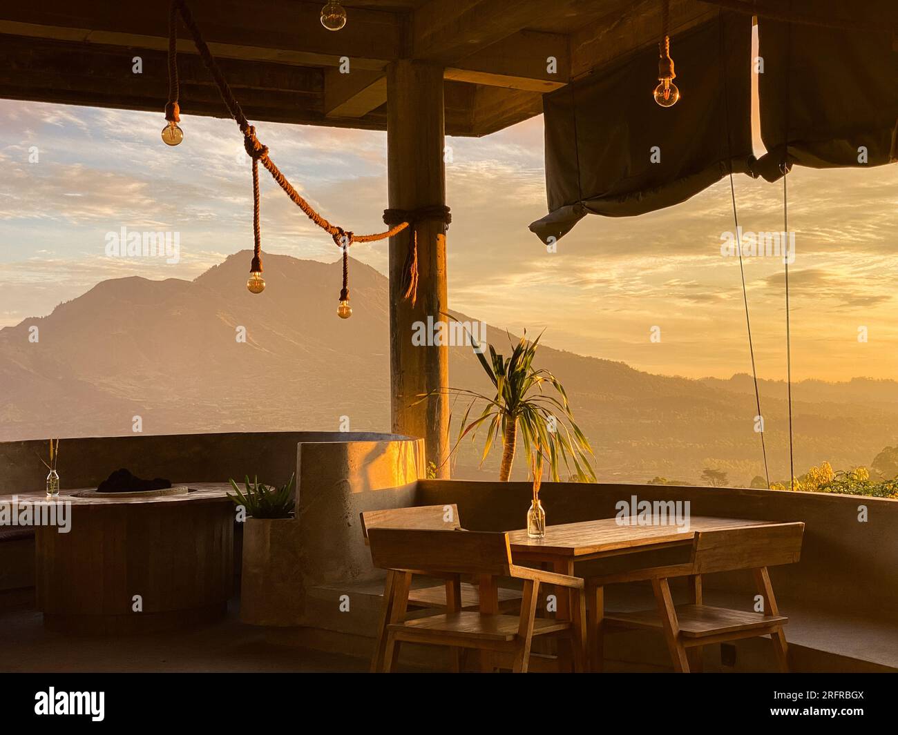 Empty cafe on sunrise with view on Batur volcano in Kintamani region ...