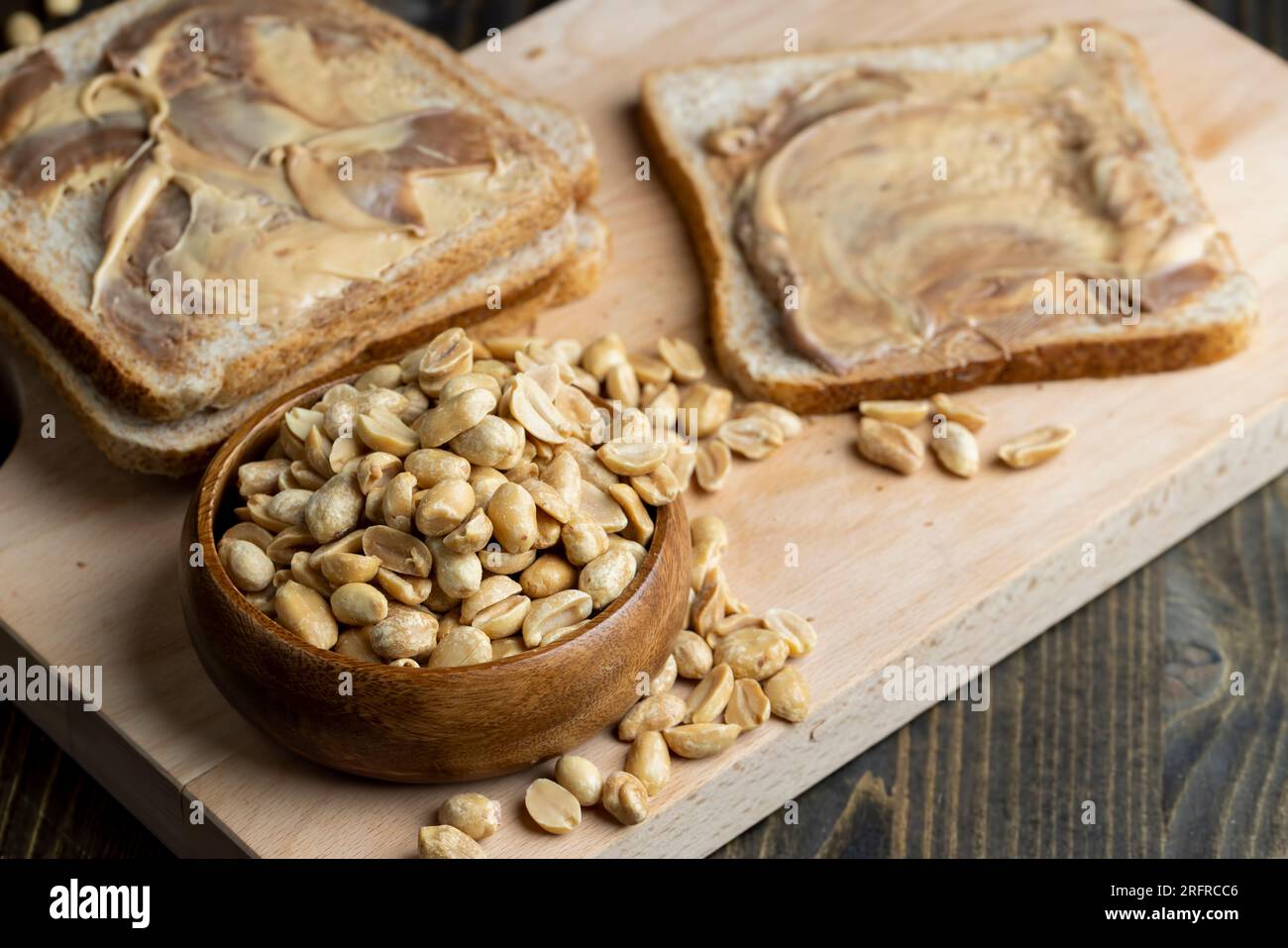 Peanut paste with chocolate paste on white bread, making sandwiches ...