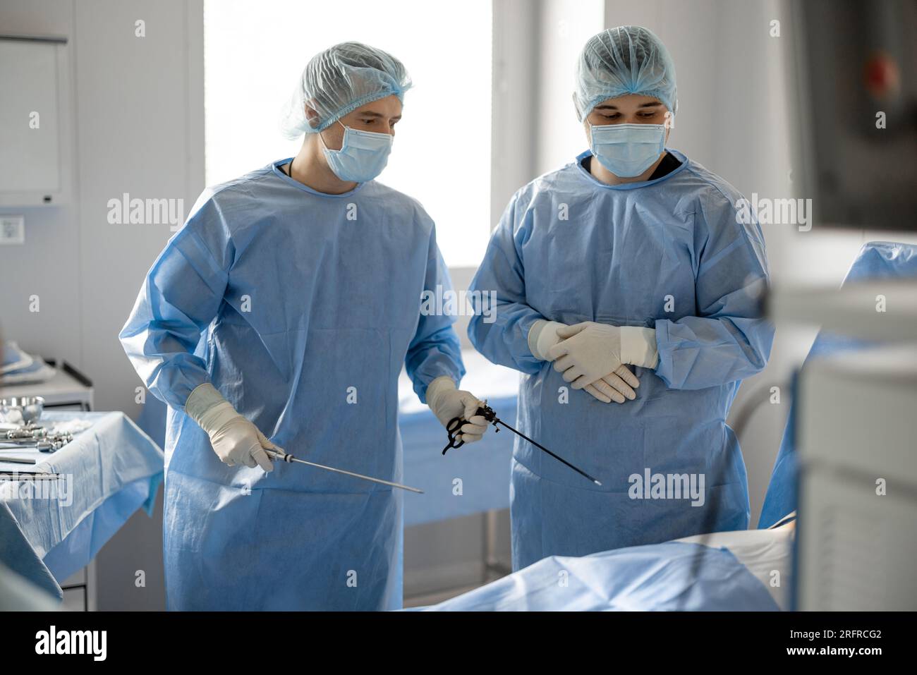 Two surgeons operating a patient with endoscopes Stock Photo - Alamy