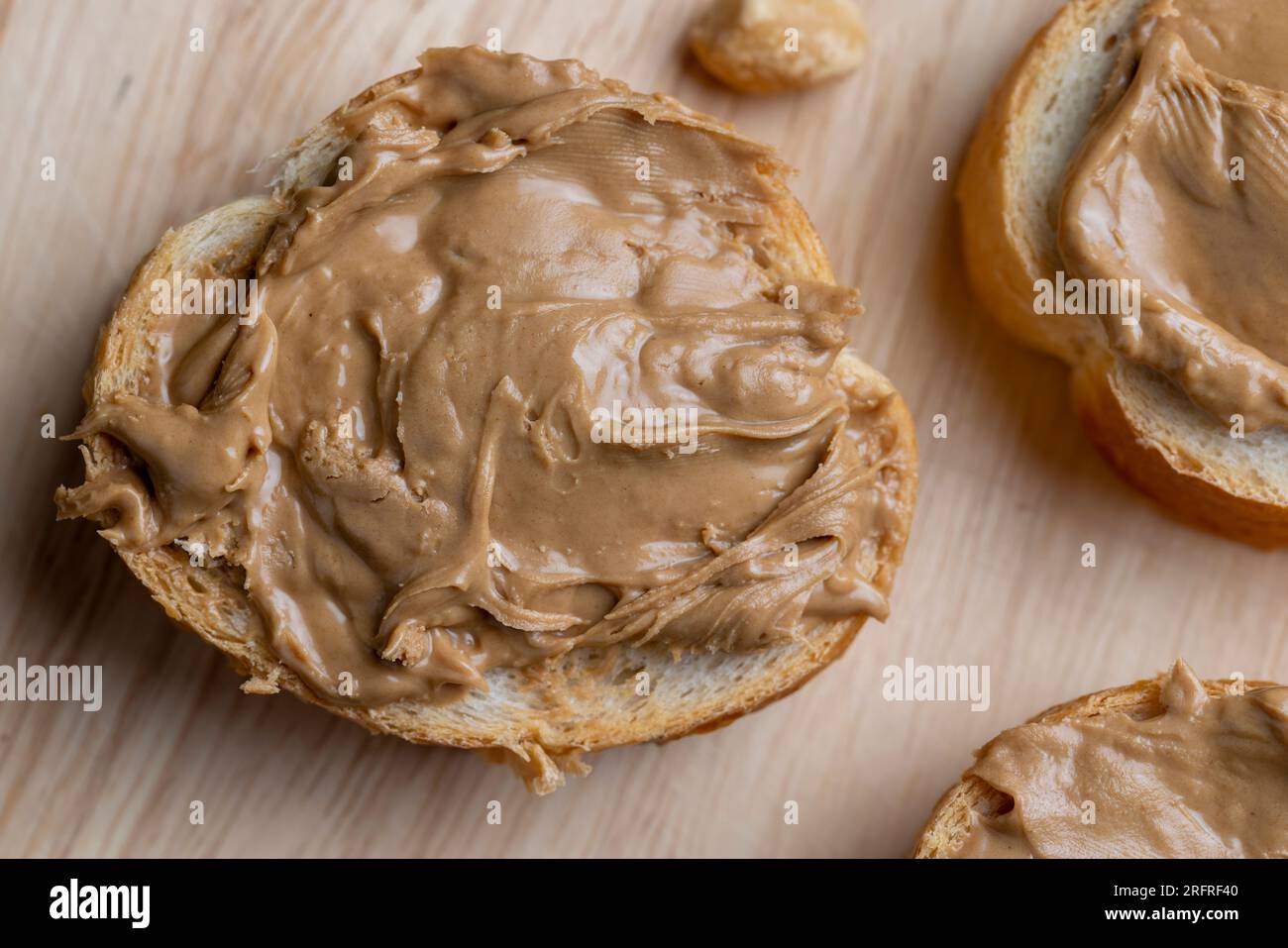 Peanut paste on a soft wheat baguette, made from peanut paste while ...