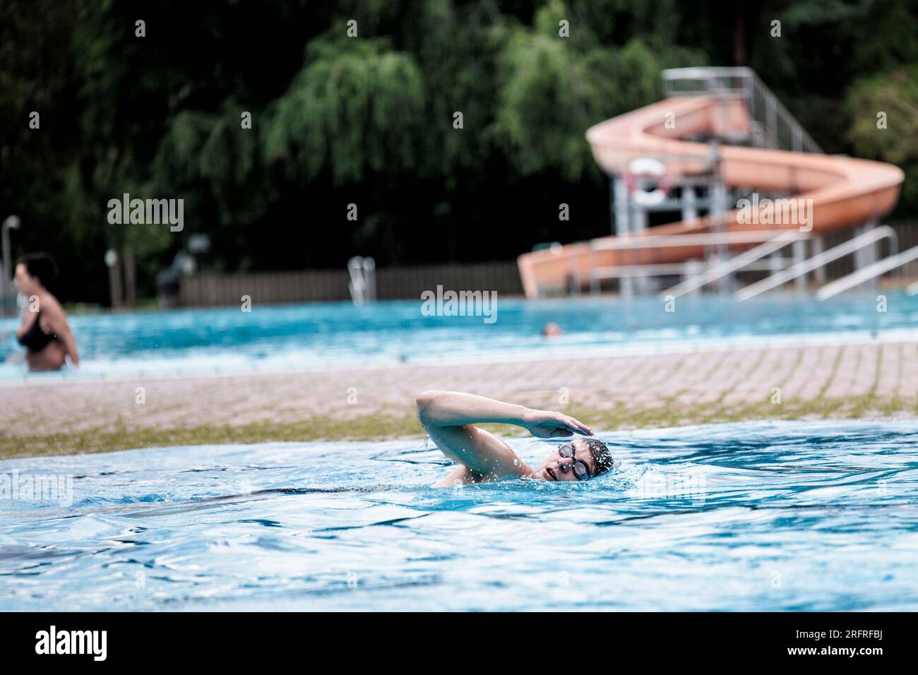 Berlin, Germany. 05th Aug, 2023. A bather swims in the pool at the ...