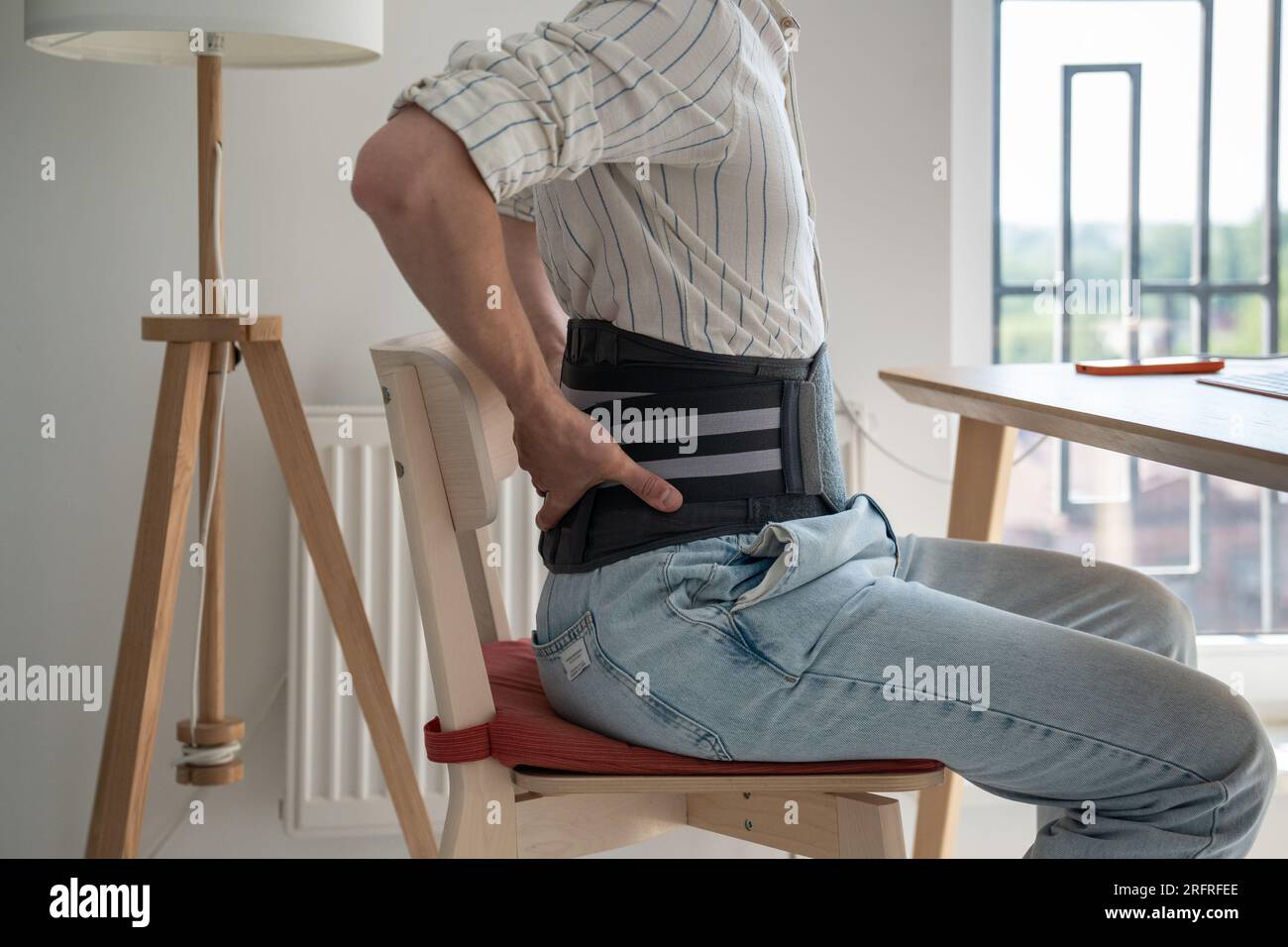 Man wearing back support belt on lower back during exacerbation to ...