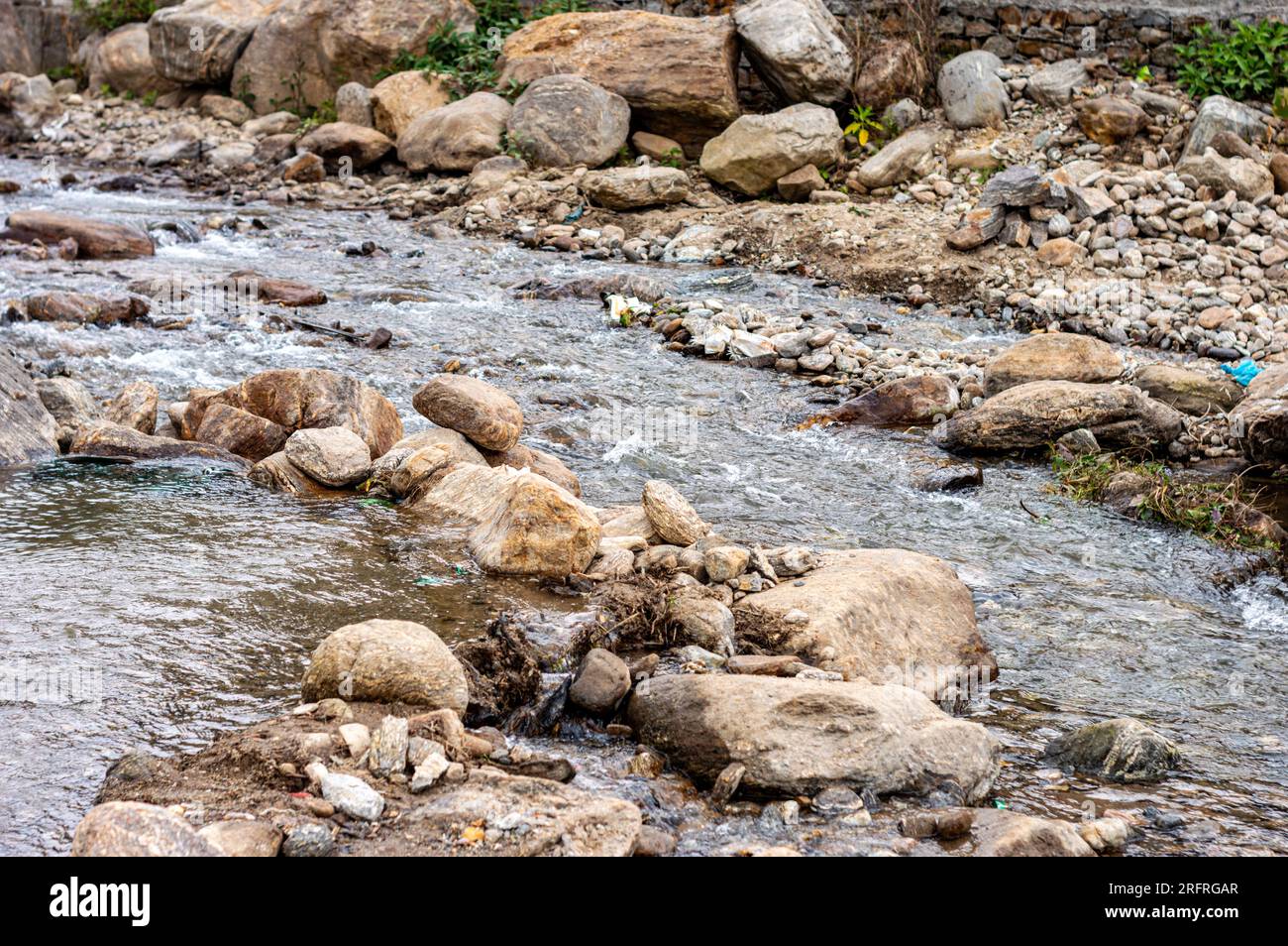 Rocky River mountain streams flowing through the rocks and pebbles of ...
