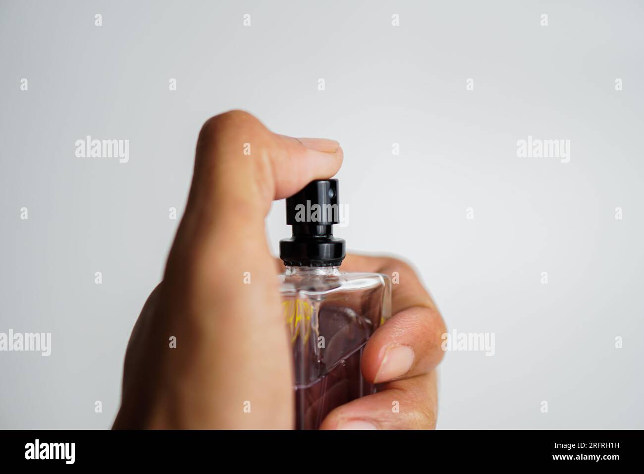 perfume bottle spraying on white background Stock Photo - Alamy