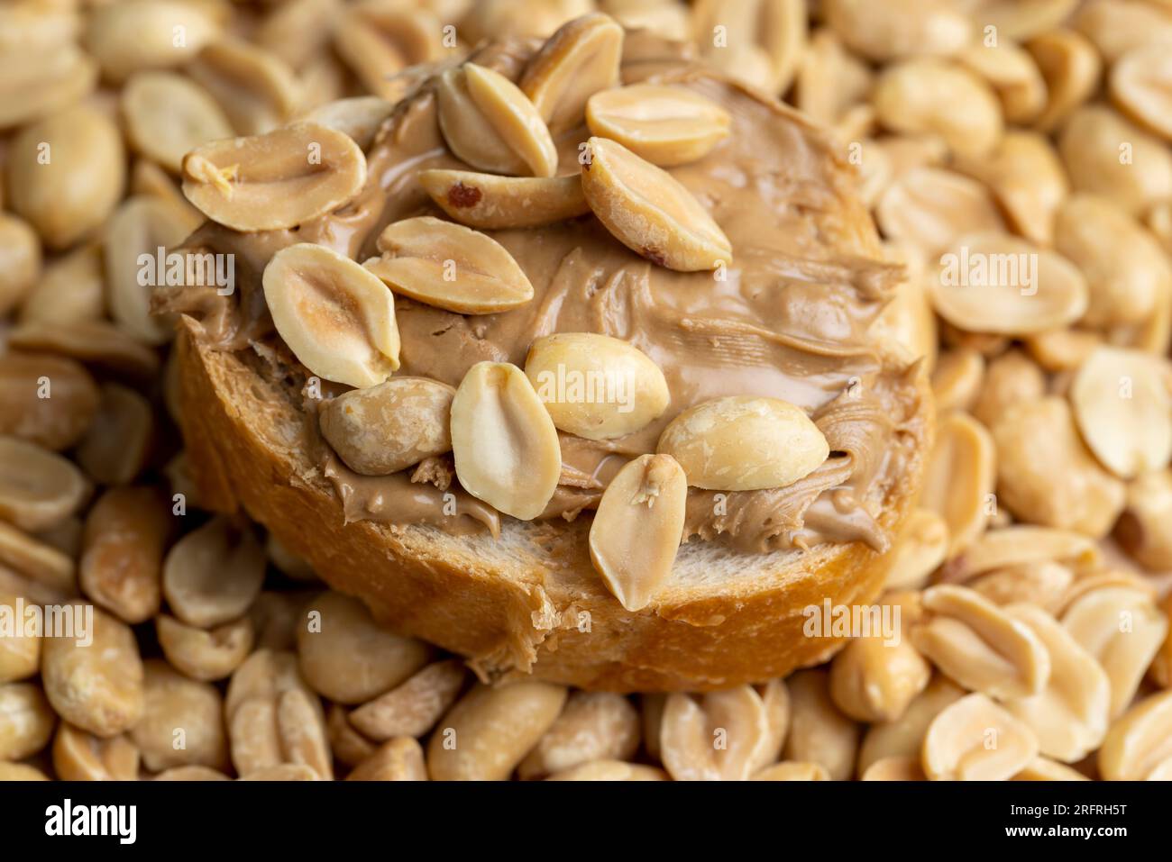 Peanut paste on a soft wheat baguette, made from peanut paste while ...